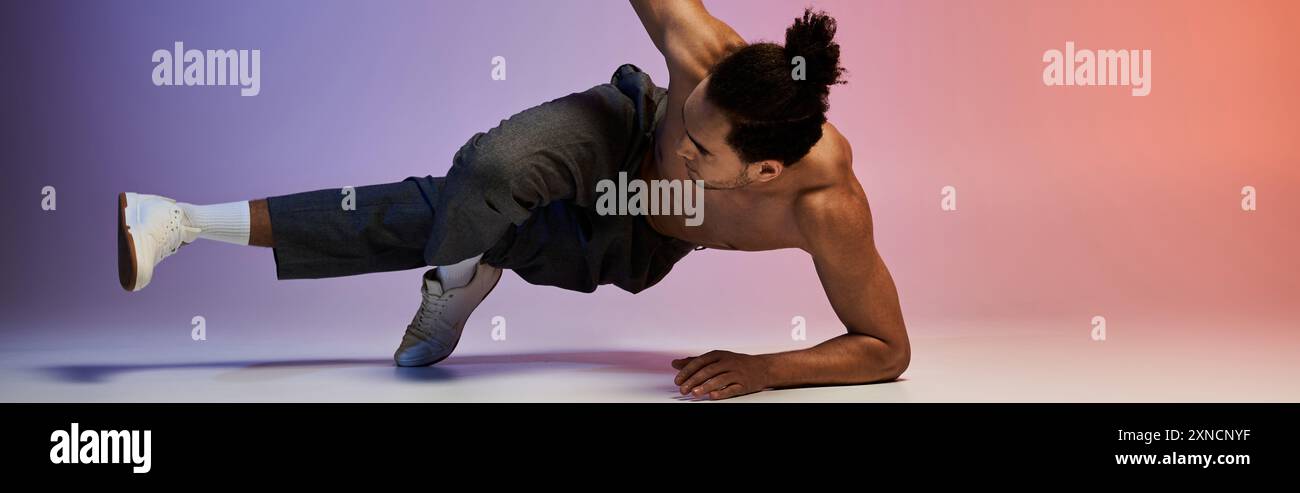 An African American male dancer performs a dynamic move against a ...
