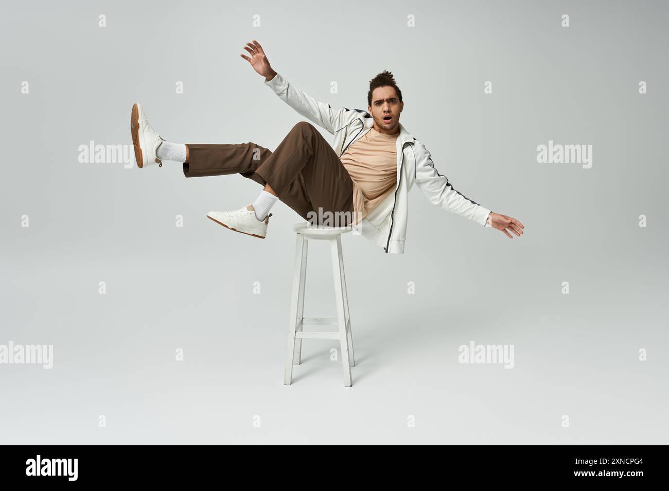 Black man sitting on stool white shirt hi-res stock photography and ...