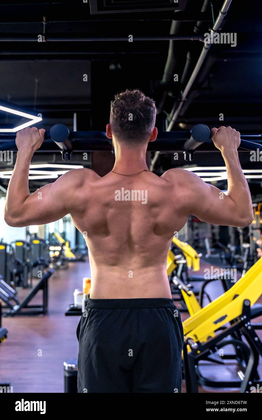 Back view of a man doing push-ups in the gym. Sports lifestyle Stock ...