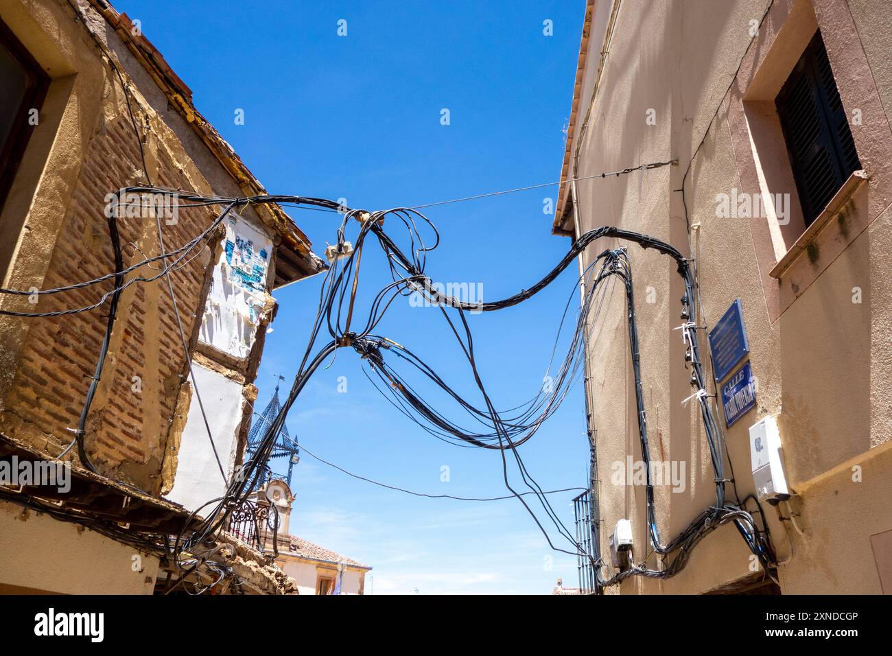 suspect dangerous Spanish electrical wiring hanging between houses in ...