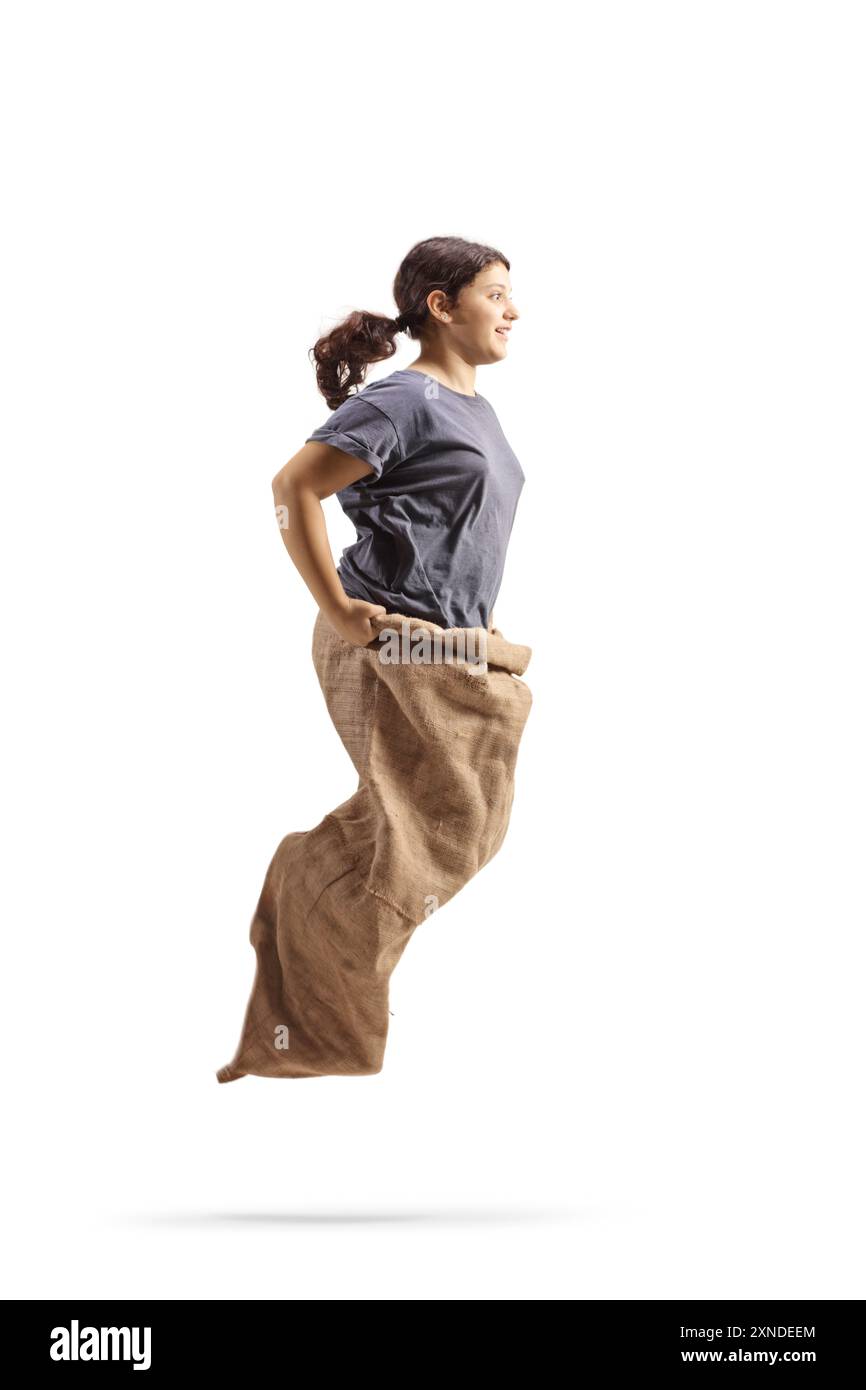 Profile shot of a teenage girl jumping in a sack and playing a sack ...