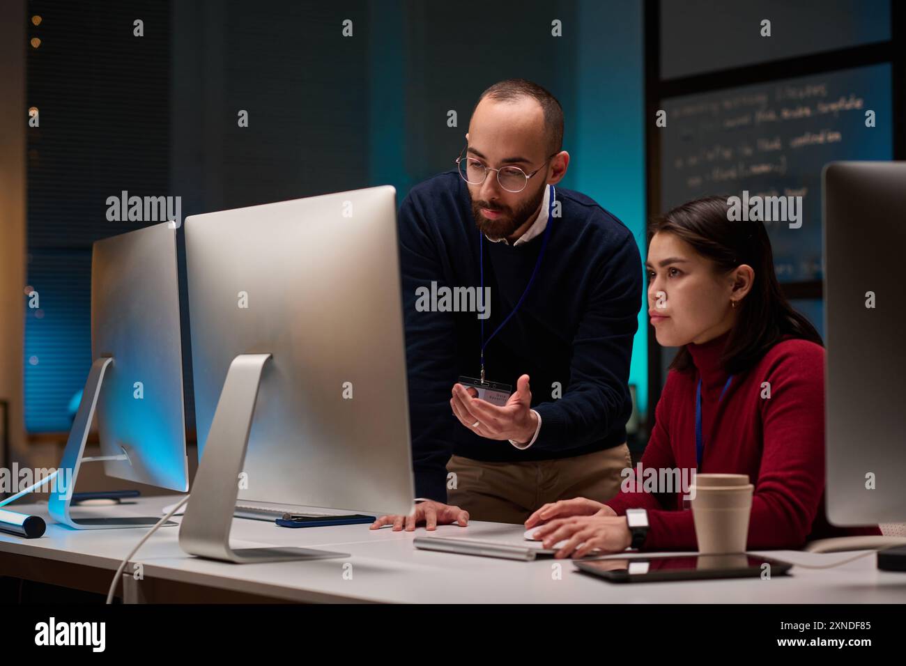 Minimal portrait of two people using computers while working in ...
