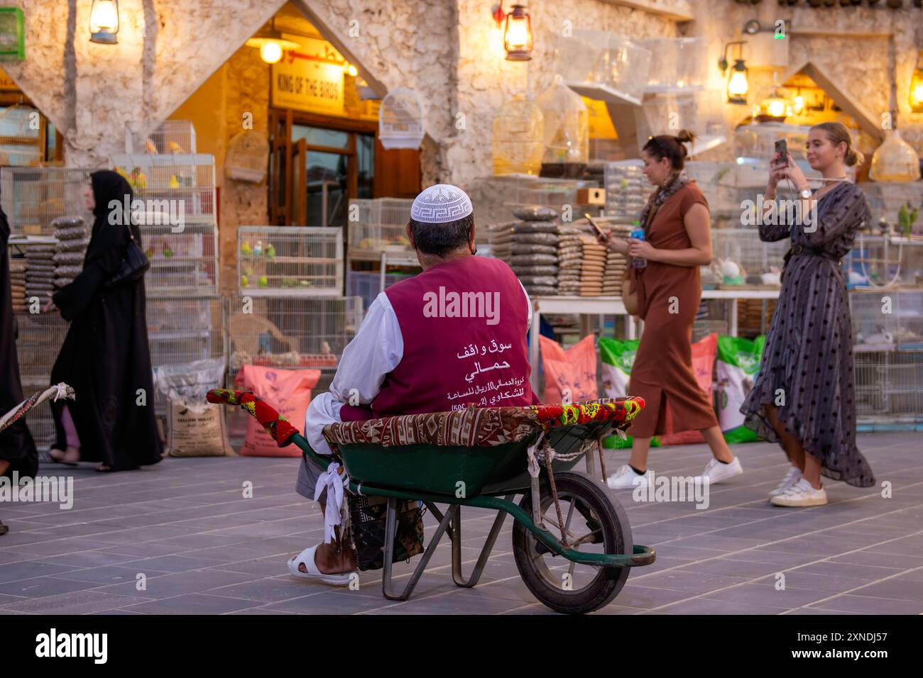Qatari people shopping at the traditional bird market Souq Waqif. Qatar ...