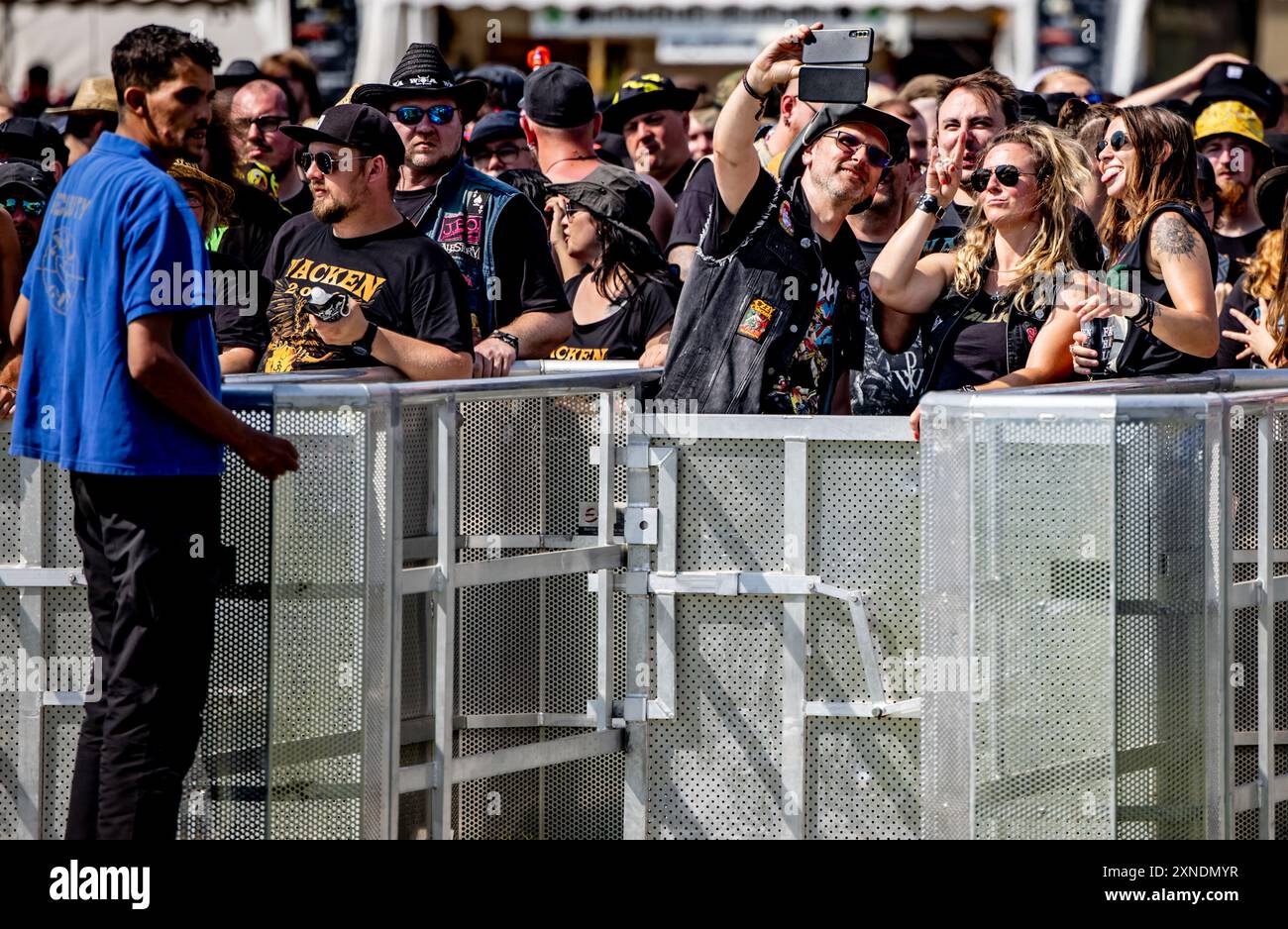 Wacken, Germany. 31st July, 2024. Festival visitors wait at the ...