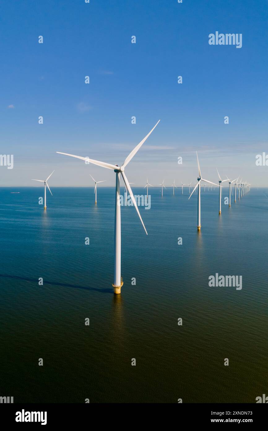 Tall wind turbines harnessing coastal winds, transforming energy into ...