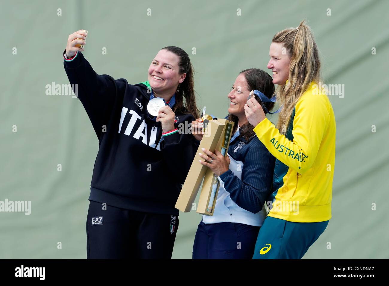 Silver medalist Italy's Silvana Maria Stanco, left, uses her phone to ...