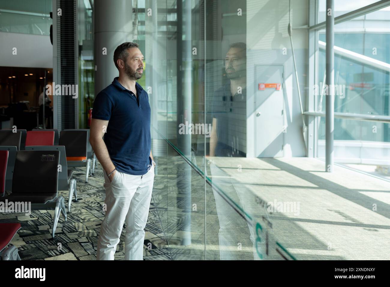 Thinking businessman against airport departure area Stock Photo - Alamy