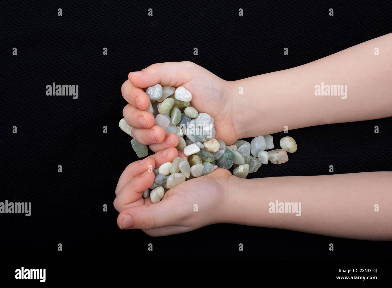 Handful of clean pebbles, gravels in hands Stock Photo - Alamy