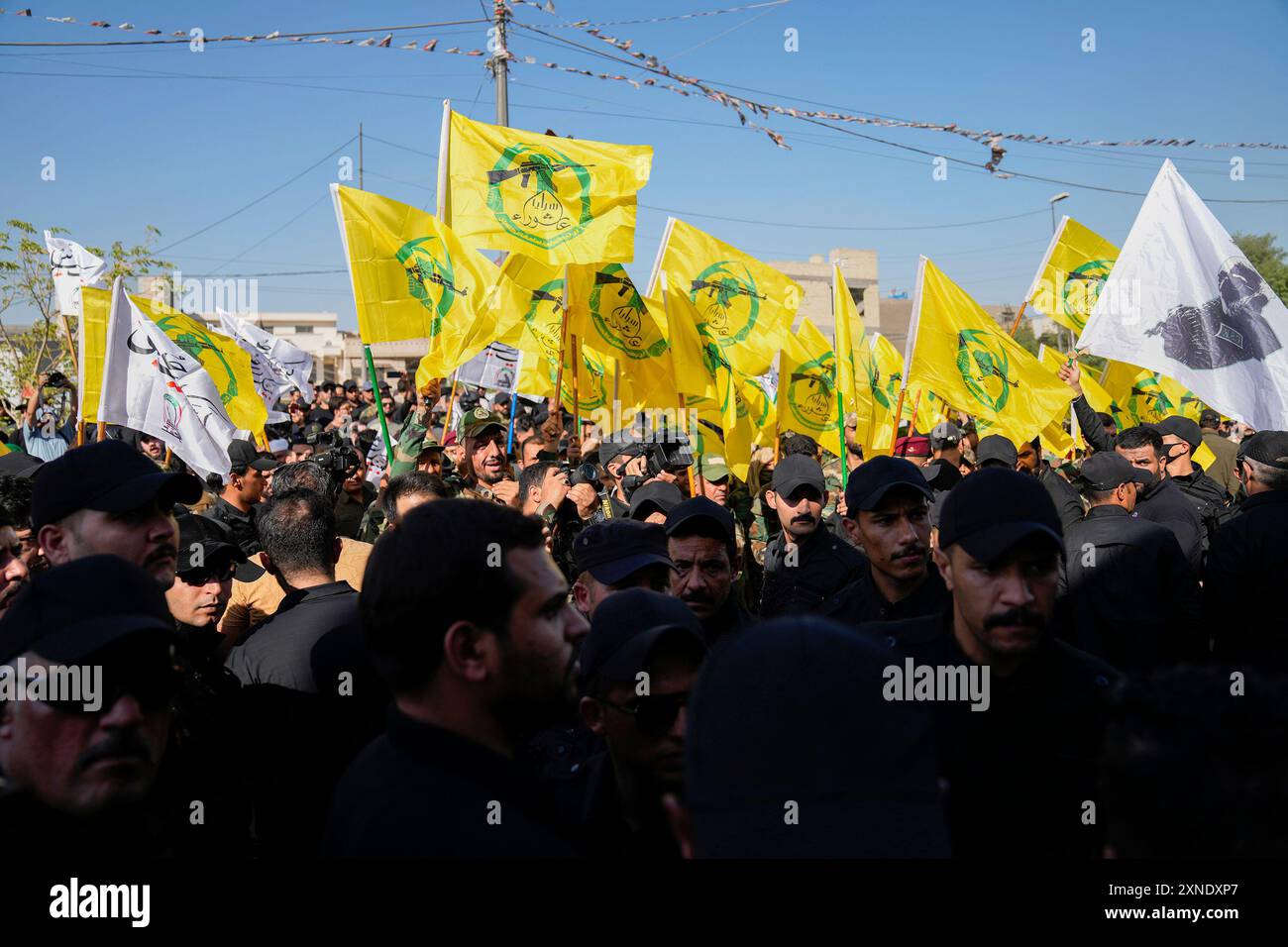 Members from the Popular Mobilization Forces attend the funeral of ...