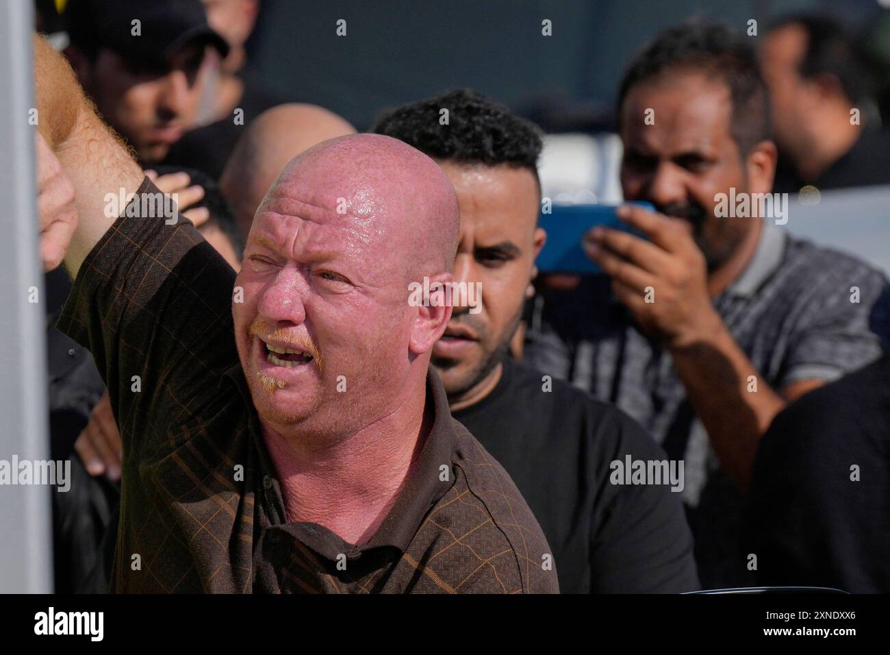 Members from the Popular Mobilization Forces attend the funeral of ...
