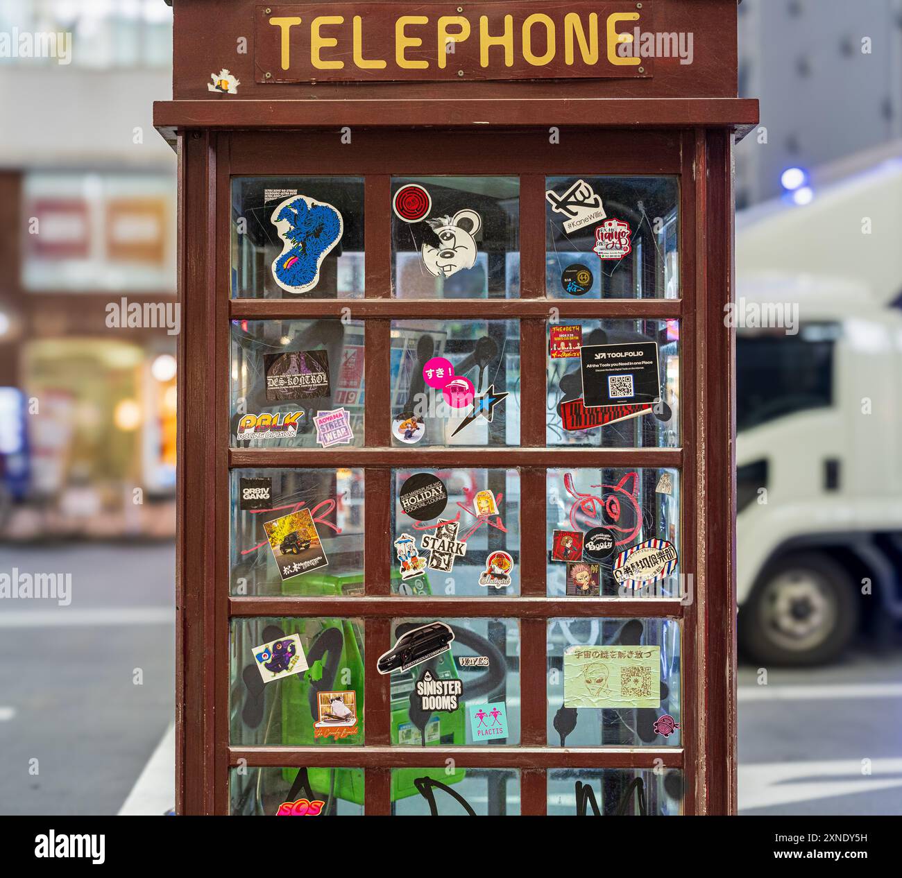 A vibrant telephone booth adorned with an abundance of stickers Stock ...