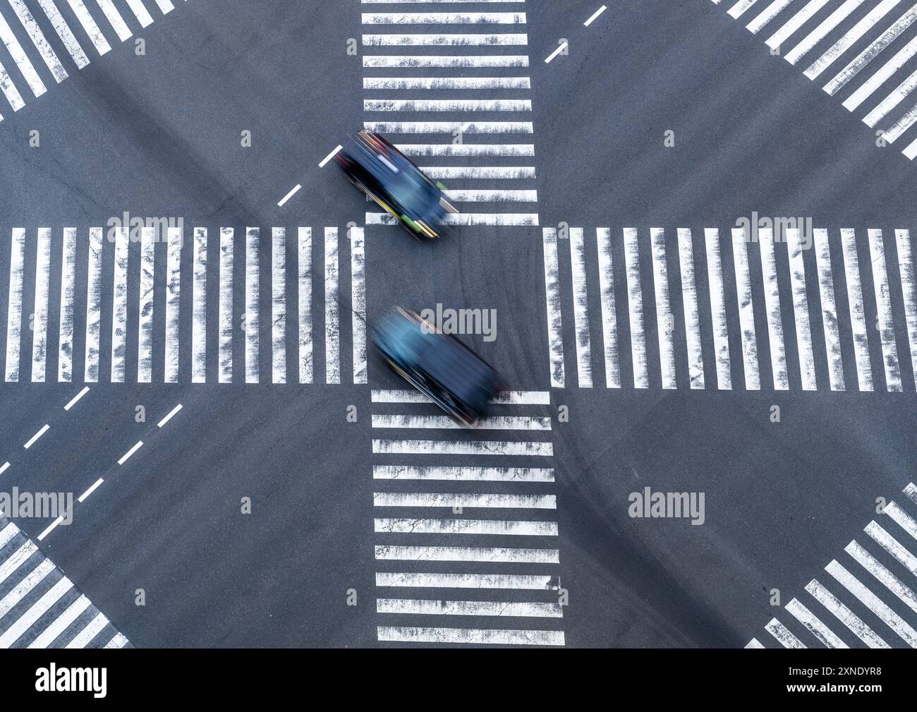 Two cars are currently driving through a designated crosswalk of Tokyo ...