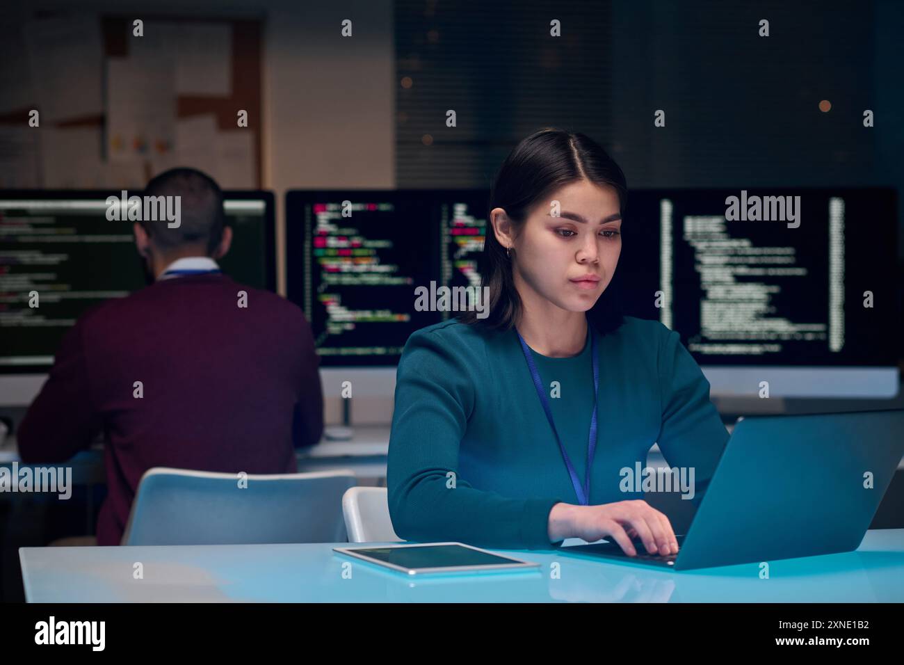 Portrait of young woman as software development expert using laptop at minimal office workplace ...