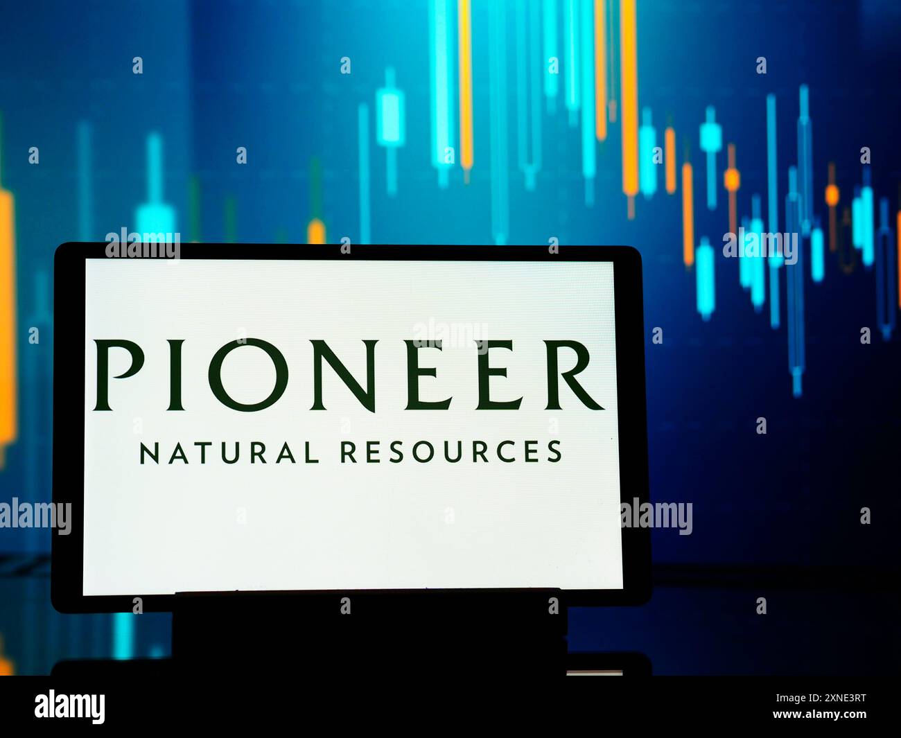In this photo illustration, a Pioneer Natural Resources Co logo seen displayed on a tablet Stock ...