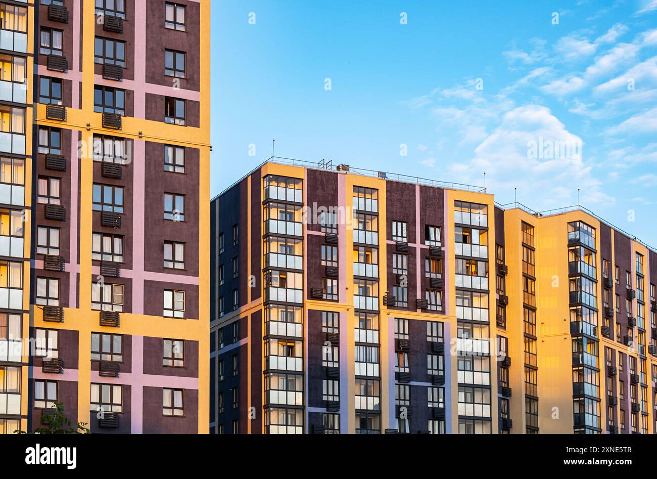 High-rise residential buildings with colorful facades during sunset ...