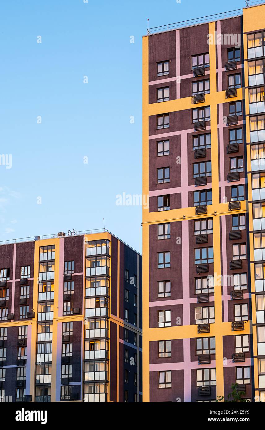 High-rise residential buildings with colorful facades during sunset ...