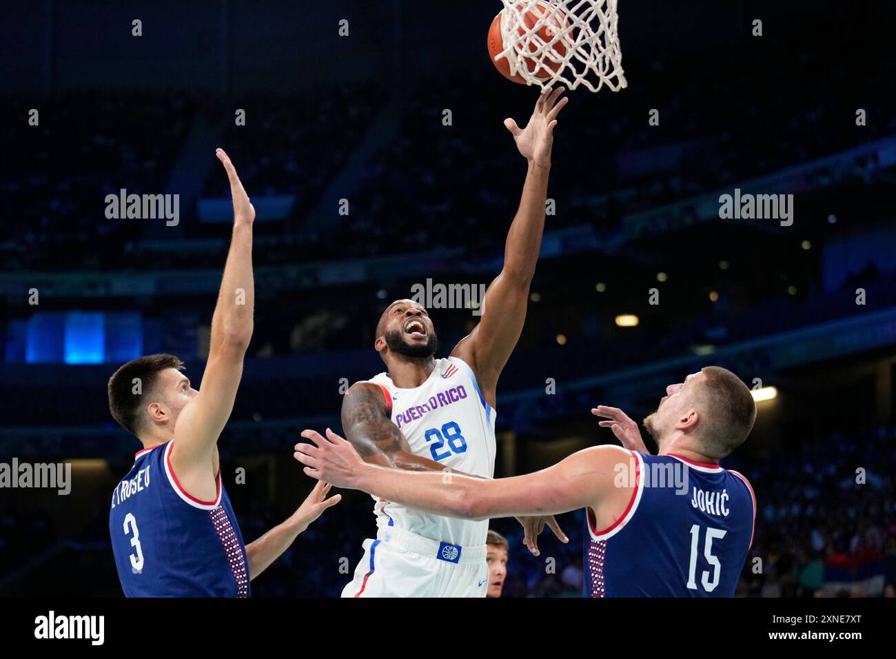 Ismael Romero, of Puerto Rico, shoots between Filip Petrusev and Nikola ...