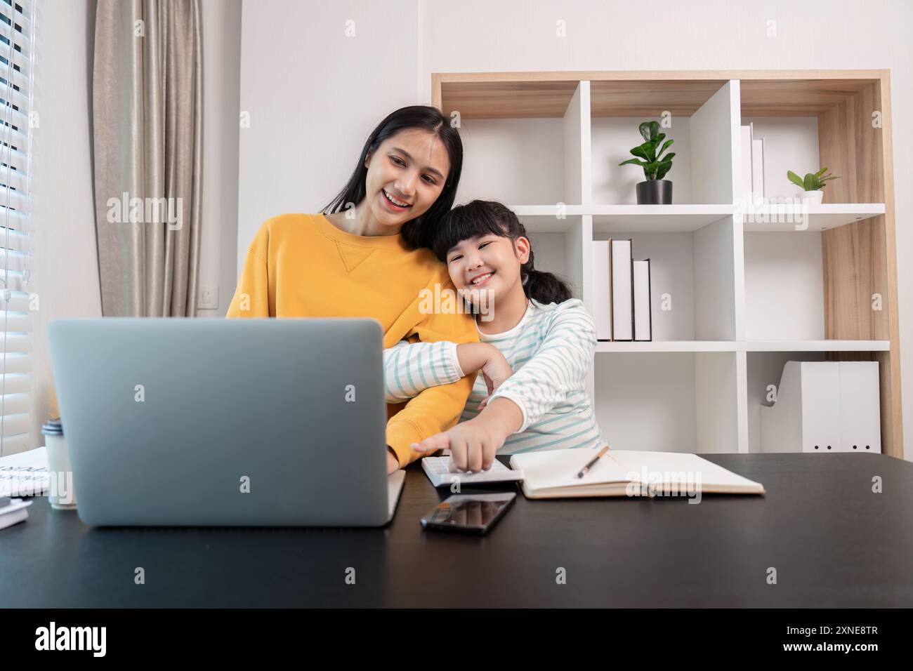 Mother and Child Working from Home Together on Laptop in Modern Home ...
