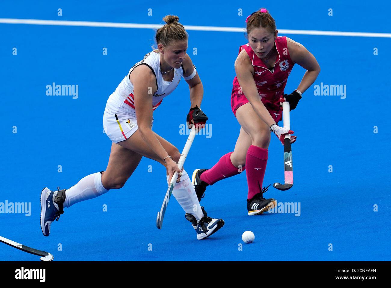 Belgium's Alix Gerniers, left, drives the ball past Japan's Hazuki ...