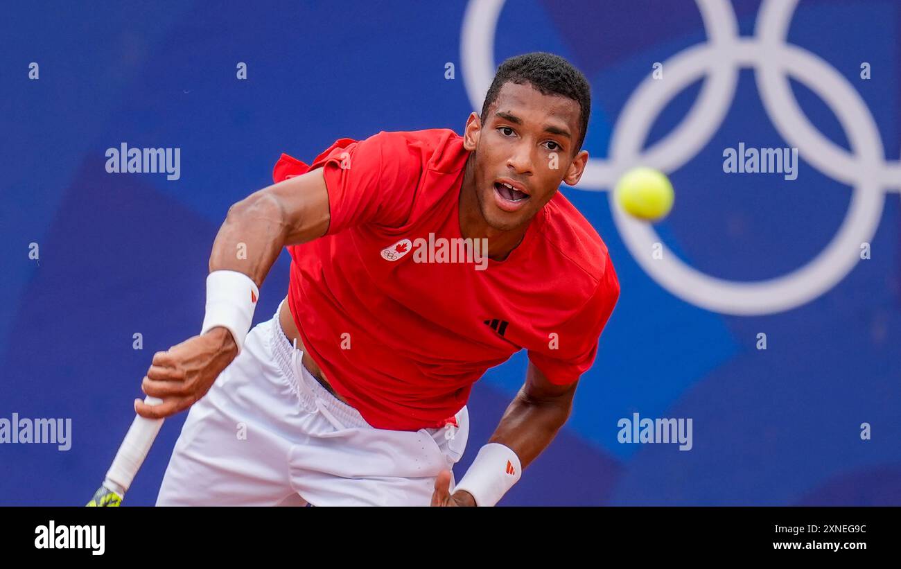 Felix Auger-Aliassime of Canada returns the ball against Daniil Medvedev of Russia during the ...