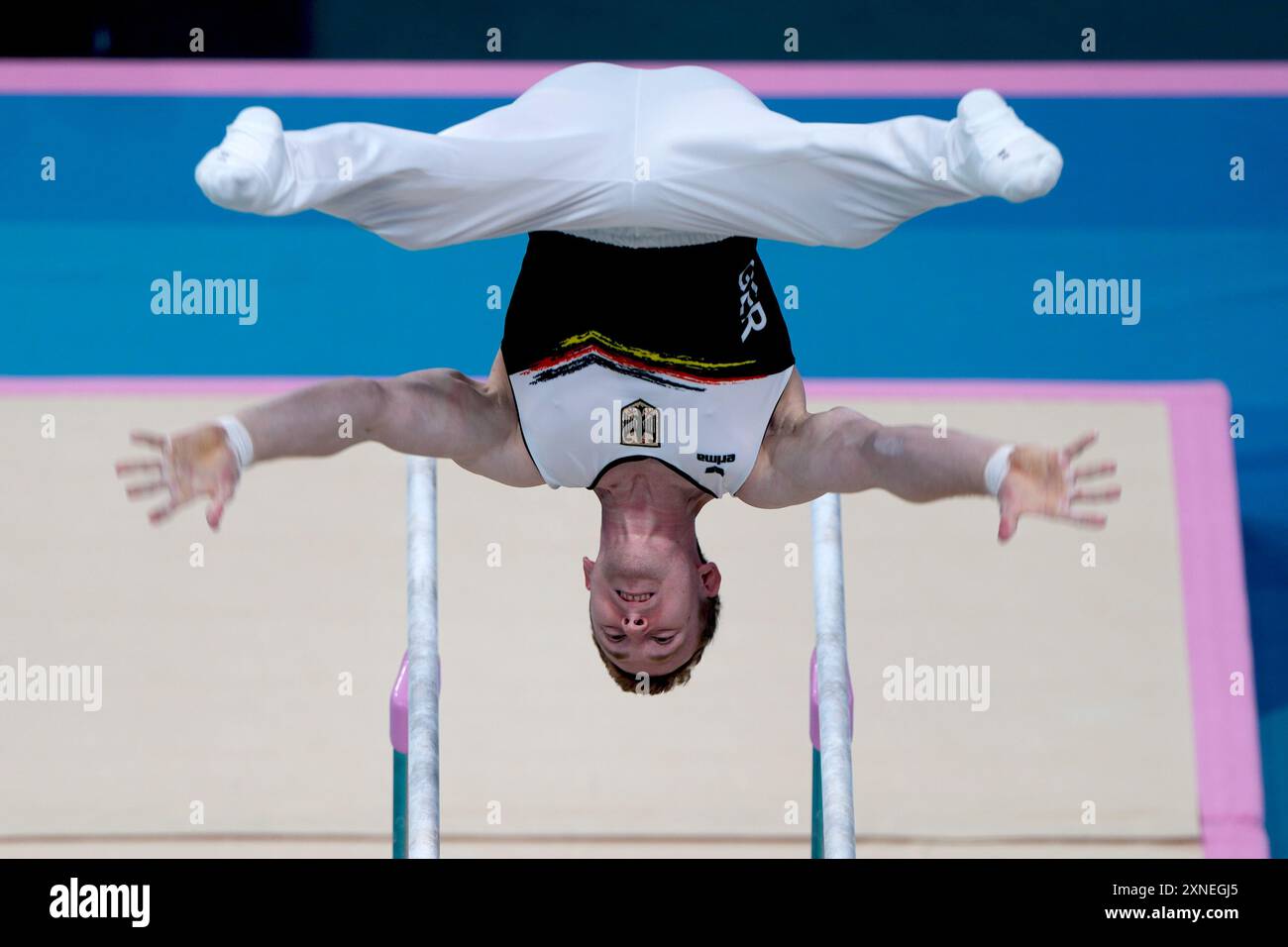 Nils Dunkel, of Germany, performs on the parallel bars during the men's ...