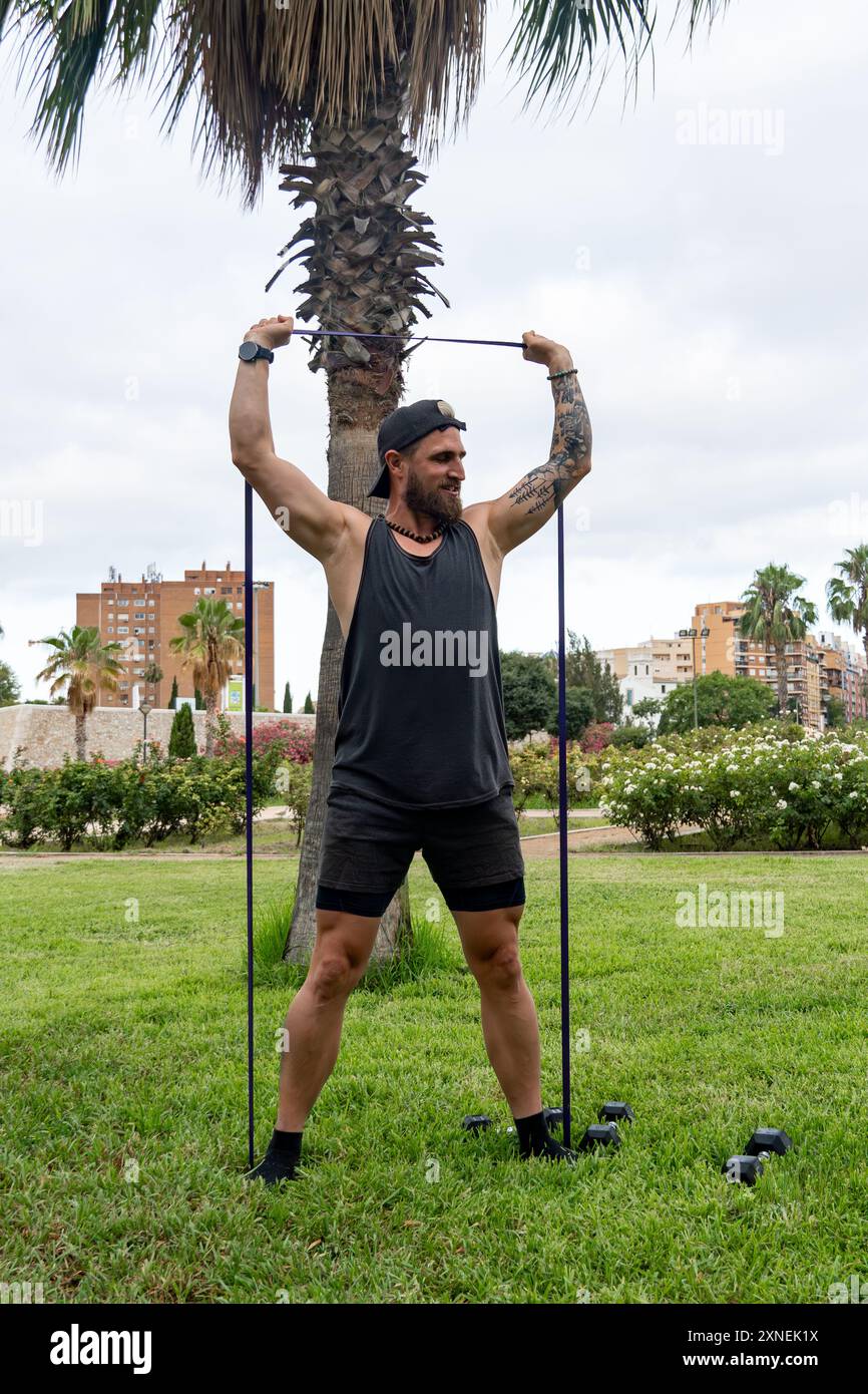 A Young Man Fully Concentrated On His Fitness Routine Uses A