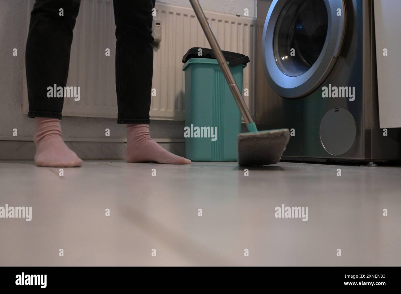Berlin, Germany. 03rd July, 2024. A woman mops the kitchen floor at ...
