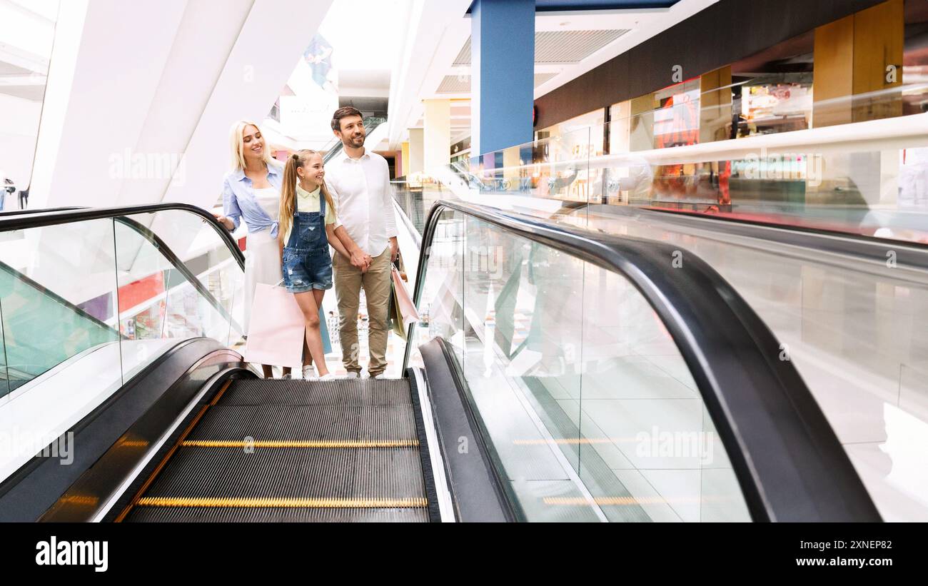 Family Riding Escalator in Modern Shopping Mall Stock Photo - Alamy
