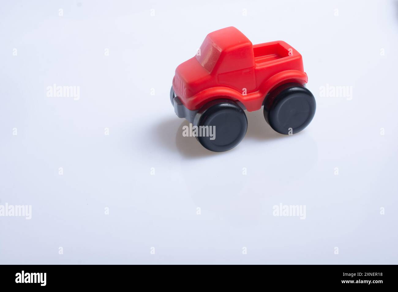 Red toy truck lorry on white background Stock Photo - Alamy