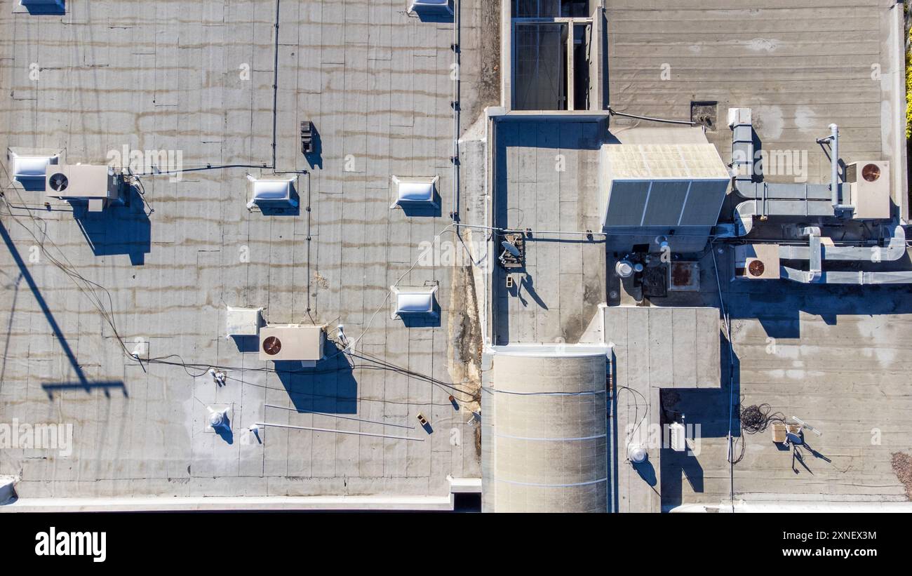 Aerial view of a flat commercial roof top with exhaust vents and air ...