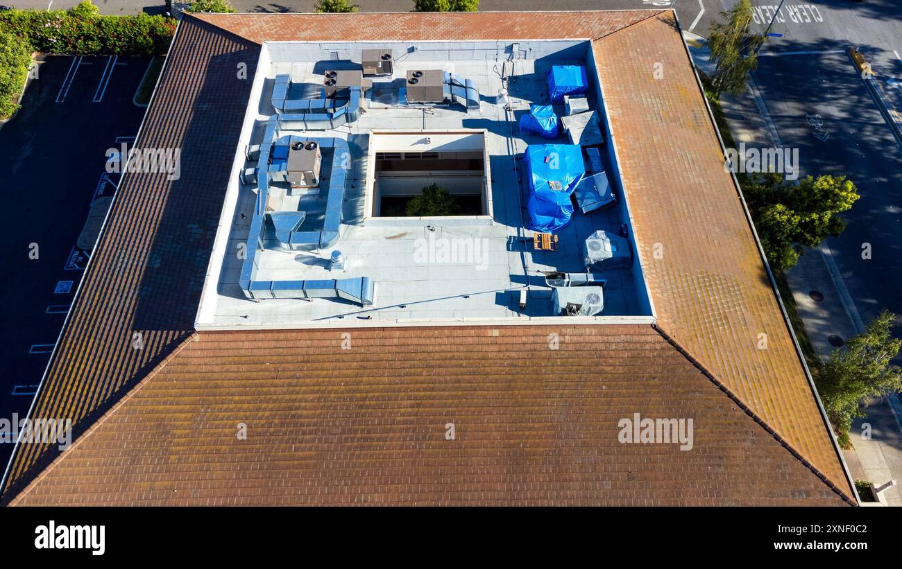 Aerial view of a commercial building rooftop with industrial HVAC units ...