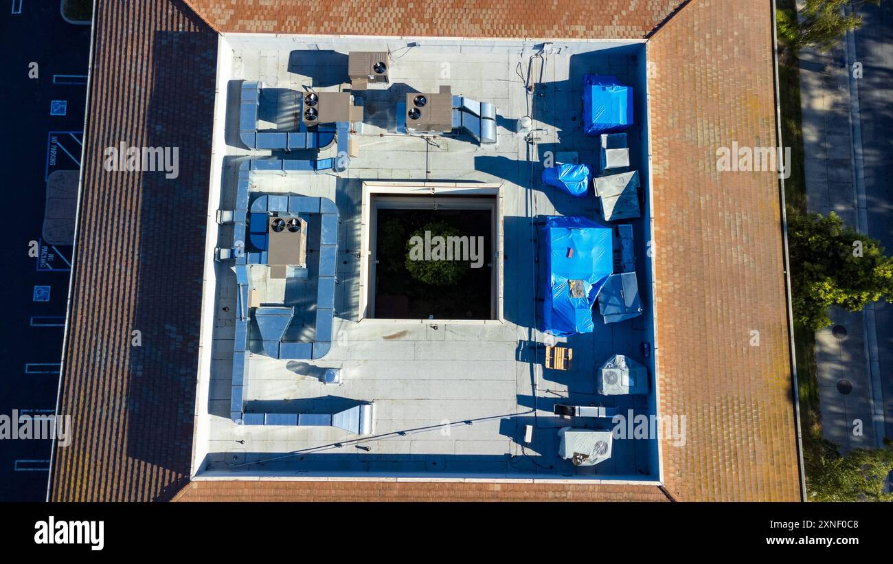 Aerial view of a commercial building rooftop with industrial HVAC units ...