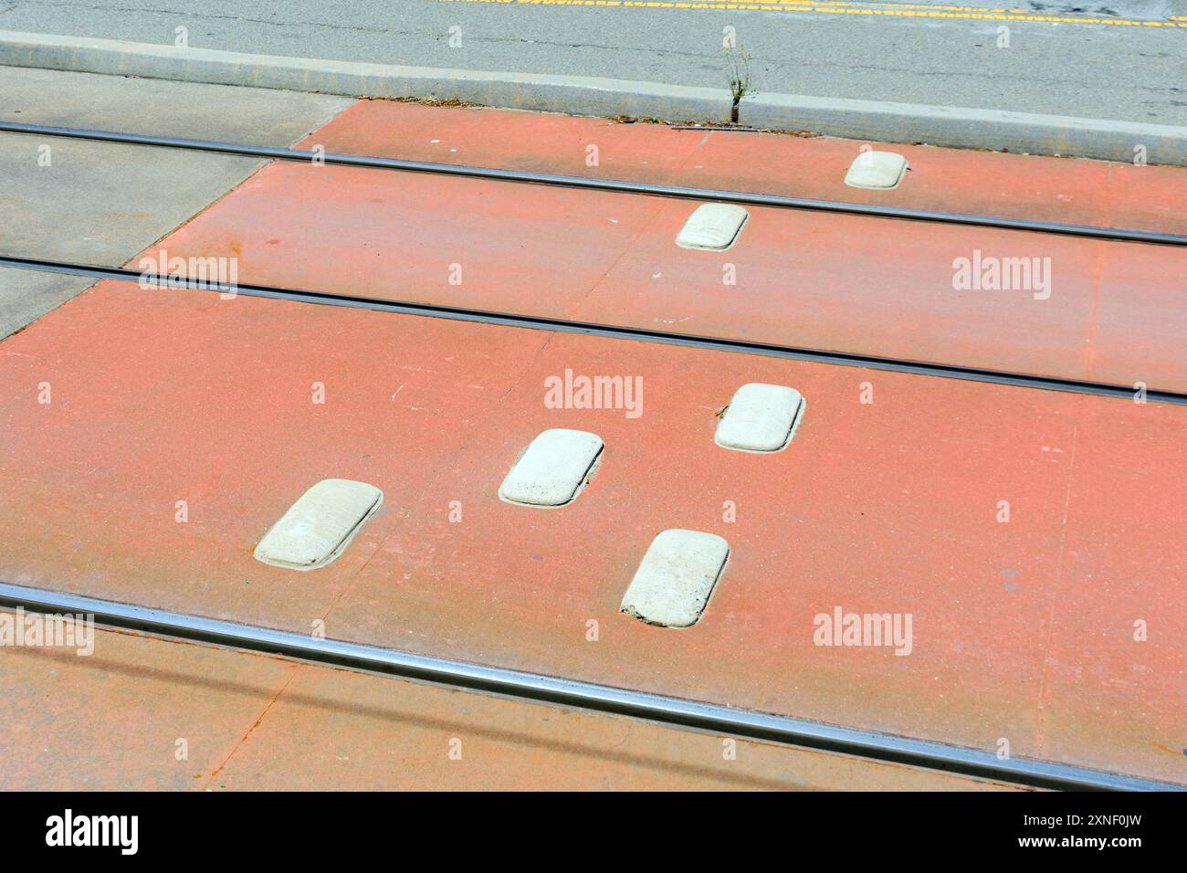 Tactile paving installed on light rail tracks to stop cars from ...