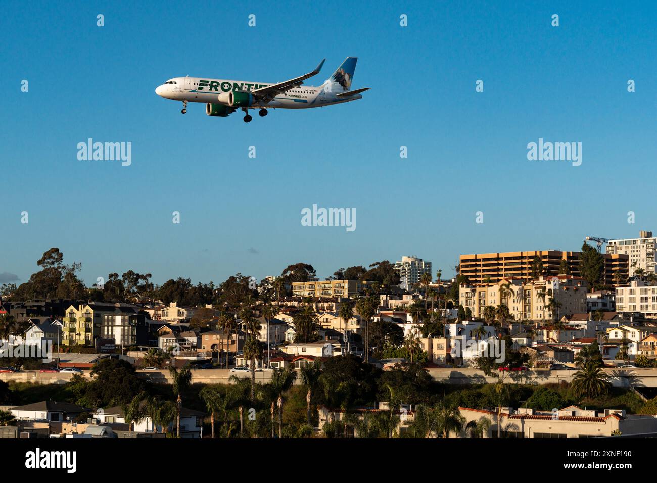 A Frontier Airlines jet on approach to land at San Diego Airport at ...