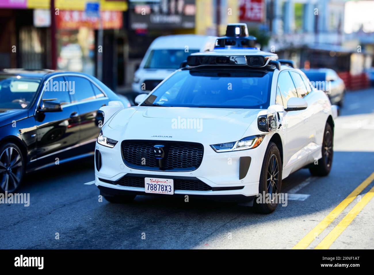 Waymo One Jaguar driverless car on urban street. Front side view ...