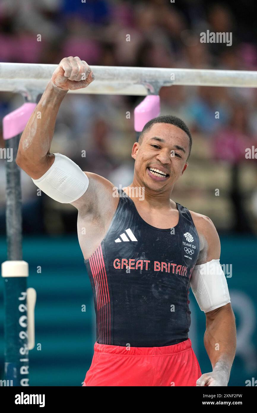Joe Fraser, of Britain, celebrates after performing on the parallel ...