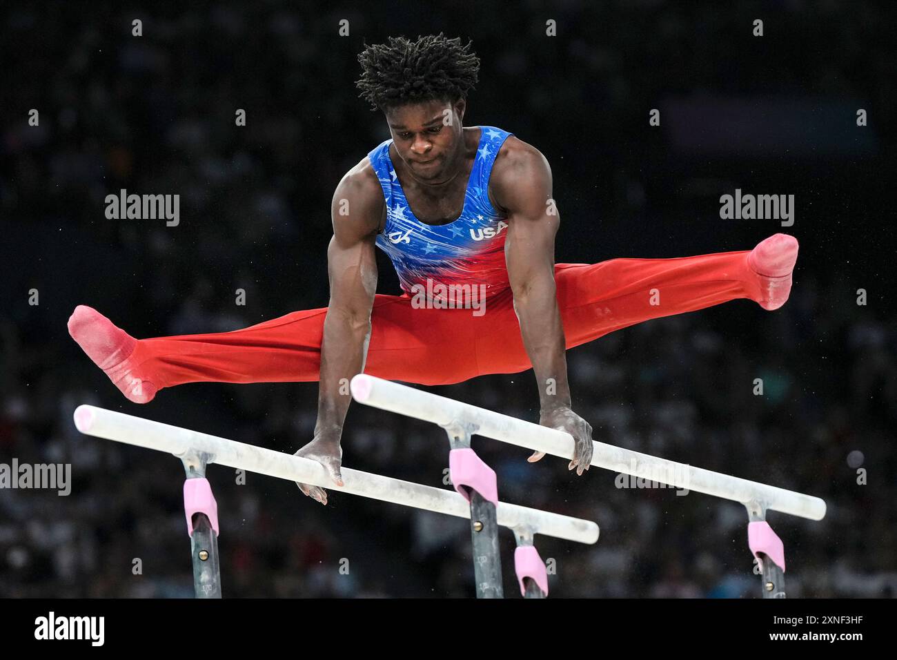 Frederick Richard, of the United States, performs on the parallel bars ...