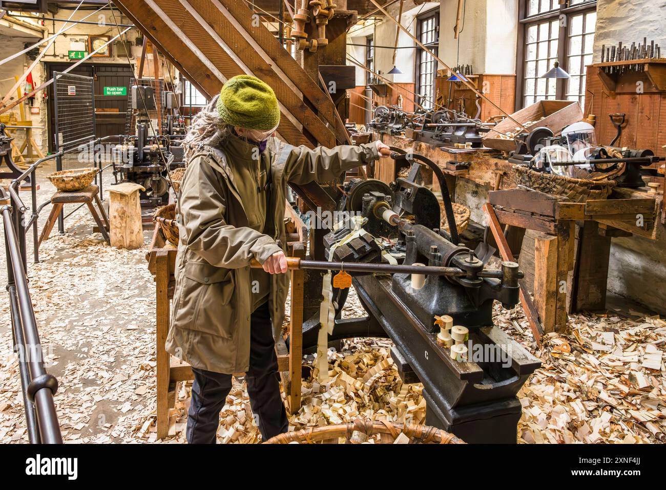 CUMBRIA, UK - April 25, 2024. Woman demonstrating machinery at Stott ...