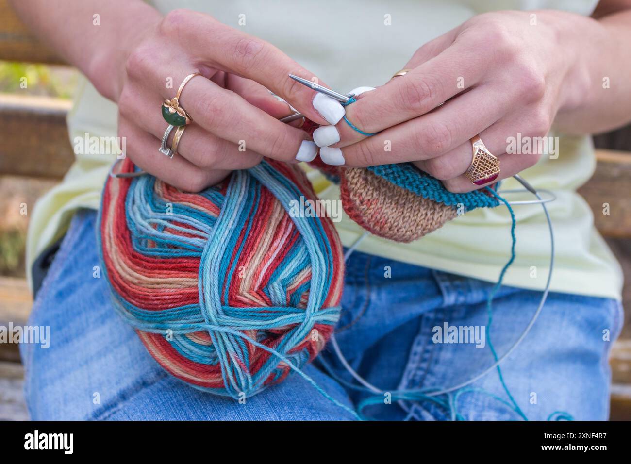 Woman hands with bright wool and knitting needles. Knitting girl ...