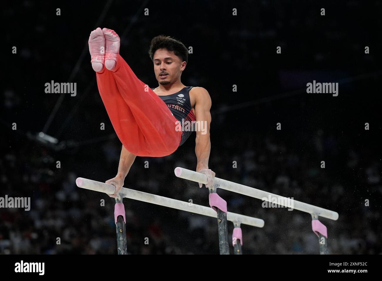 Jake Jarman, of Britain, performs on the parallel bars during the men's ...