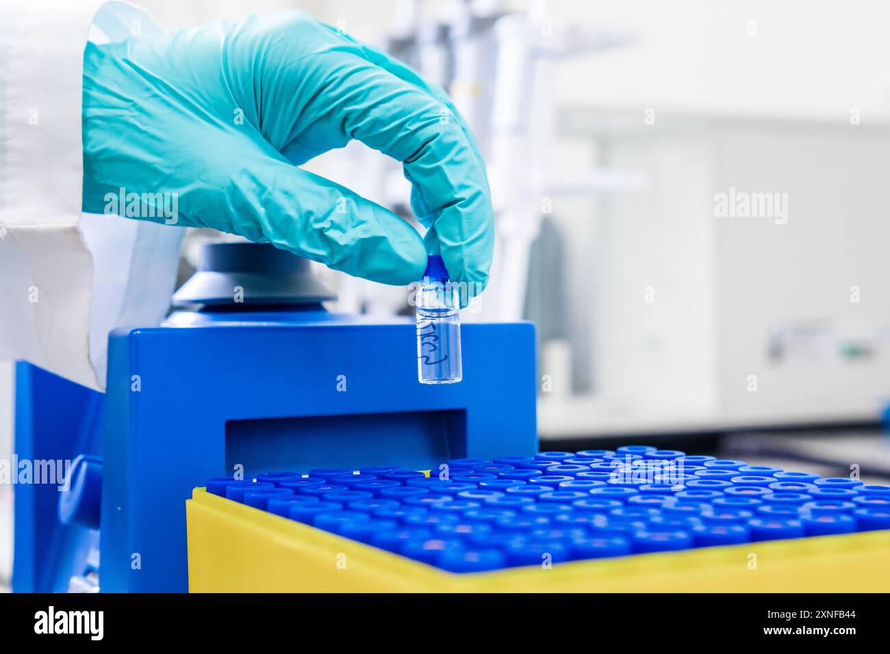Shaking samples with a vortex mixer, a chemist prepares them for HPLC ...