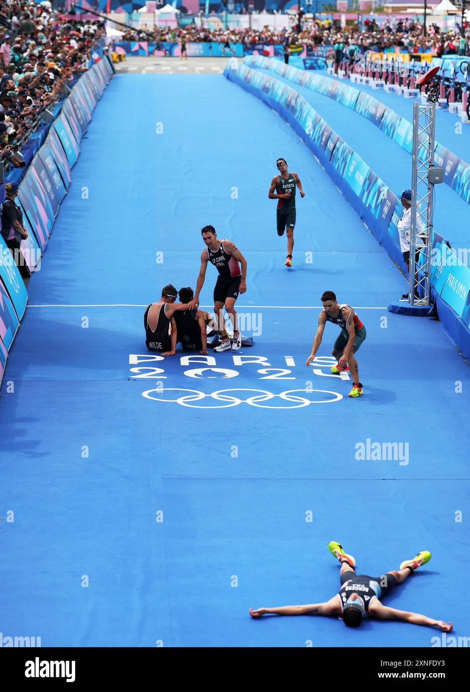 Paris, France. 31st July, 2024. Athletes react after passing the finish ...