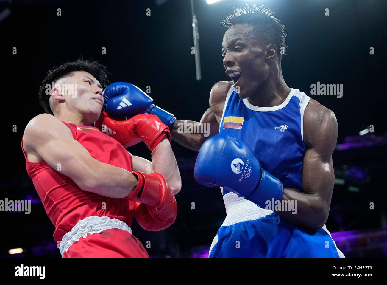 Colombia's Yilmar Gonzalez hits Japan's Shudai Harada in their men's 57 ...