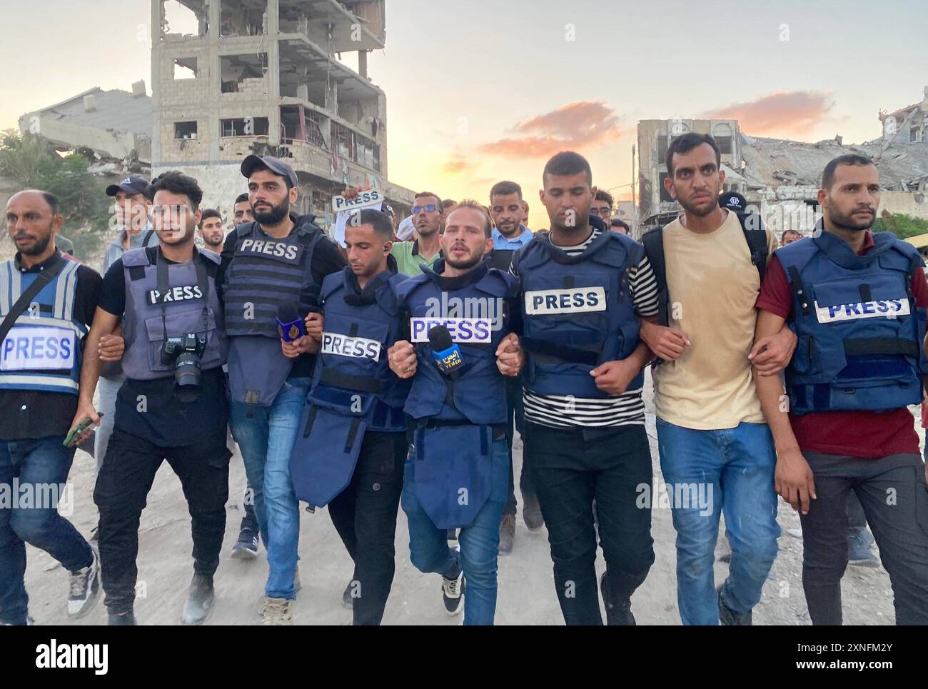 Mourners and colleagues surround the bodyies of Al-Jazeera Arabic ...