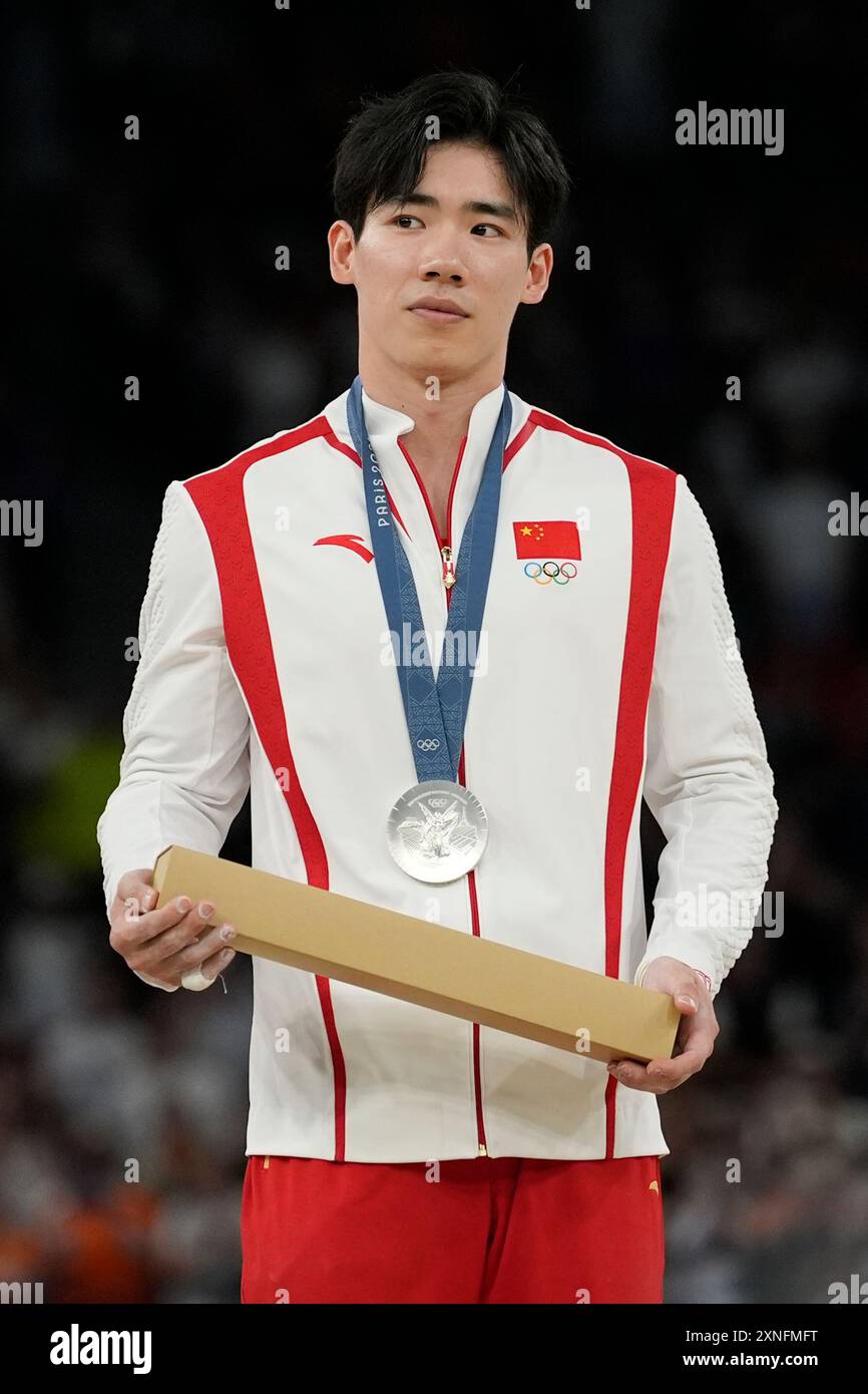 Zhang Boheng, of China, stands on the podium after winning the silver ...