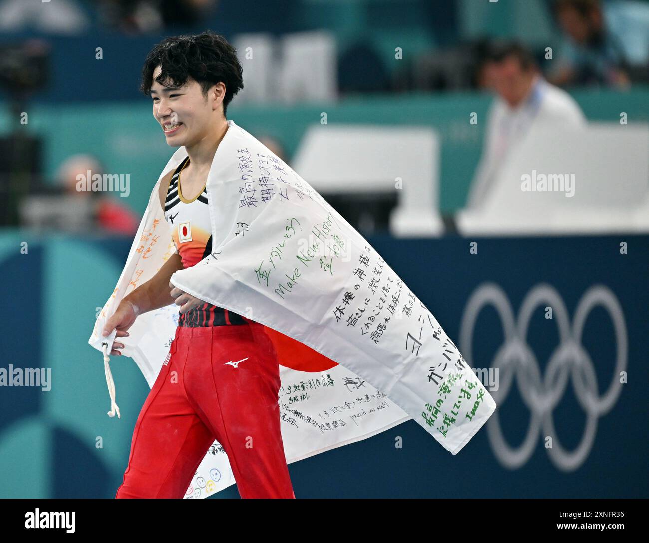 Japan's Shinnosuke Oka holds the national flag after winning the Men's ...