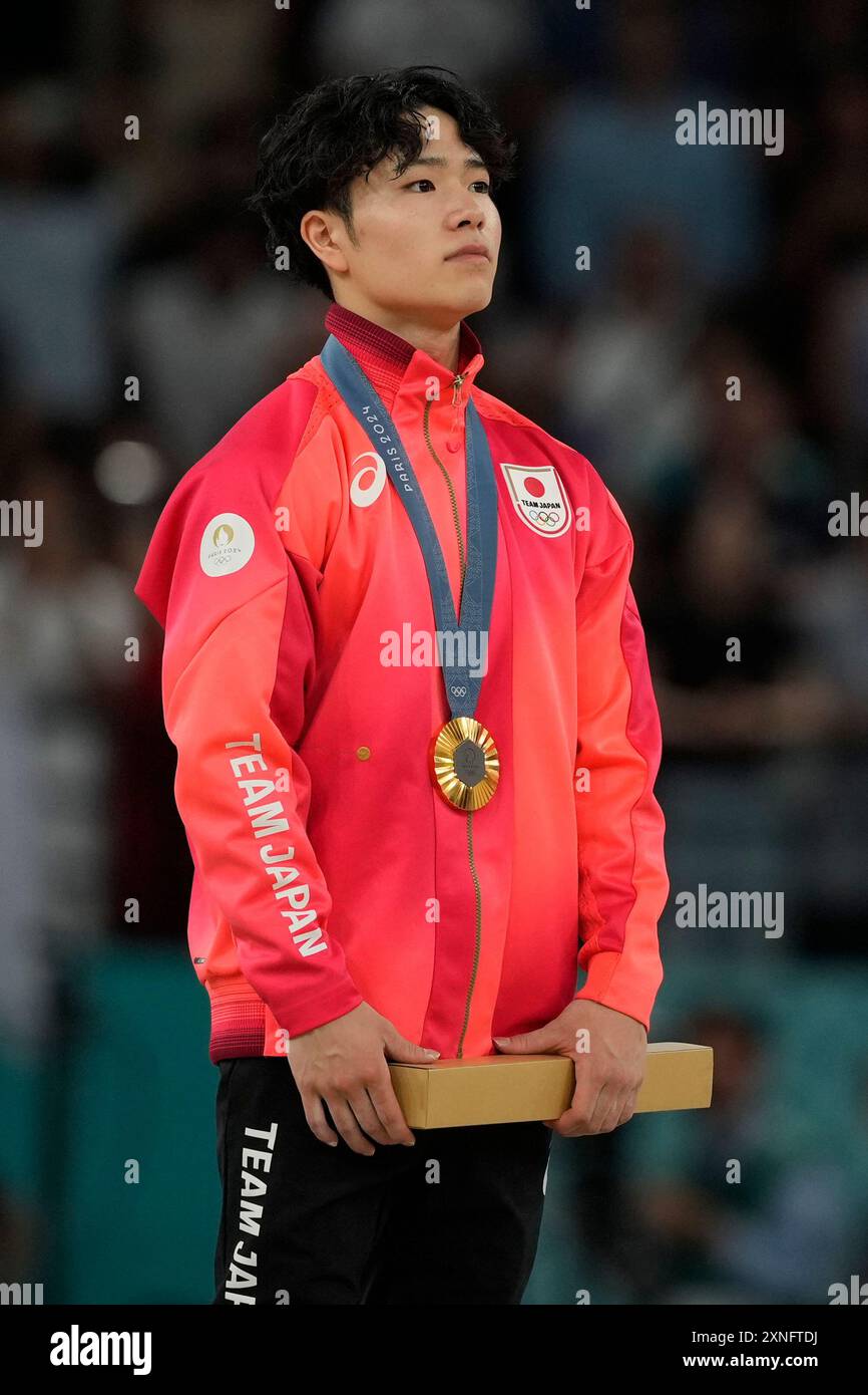 Shinnosuke Oka, of Japan, stands on the podium after winning the gold medal during the men's ...