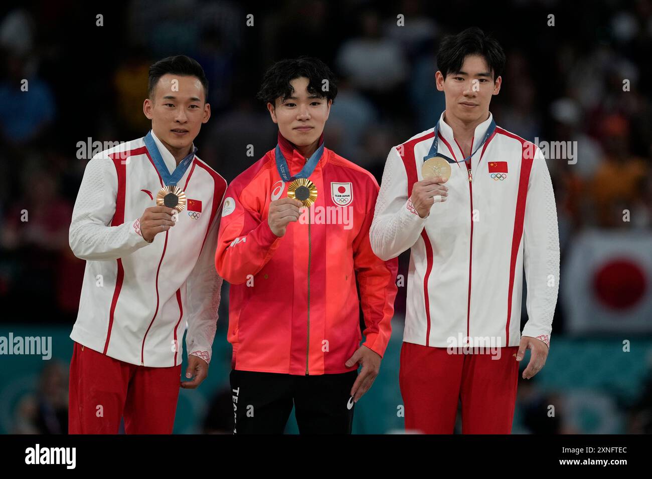 Shinnosuke Oka, center, of Japan, poses with his gold medal alongside ...