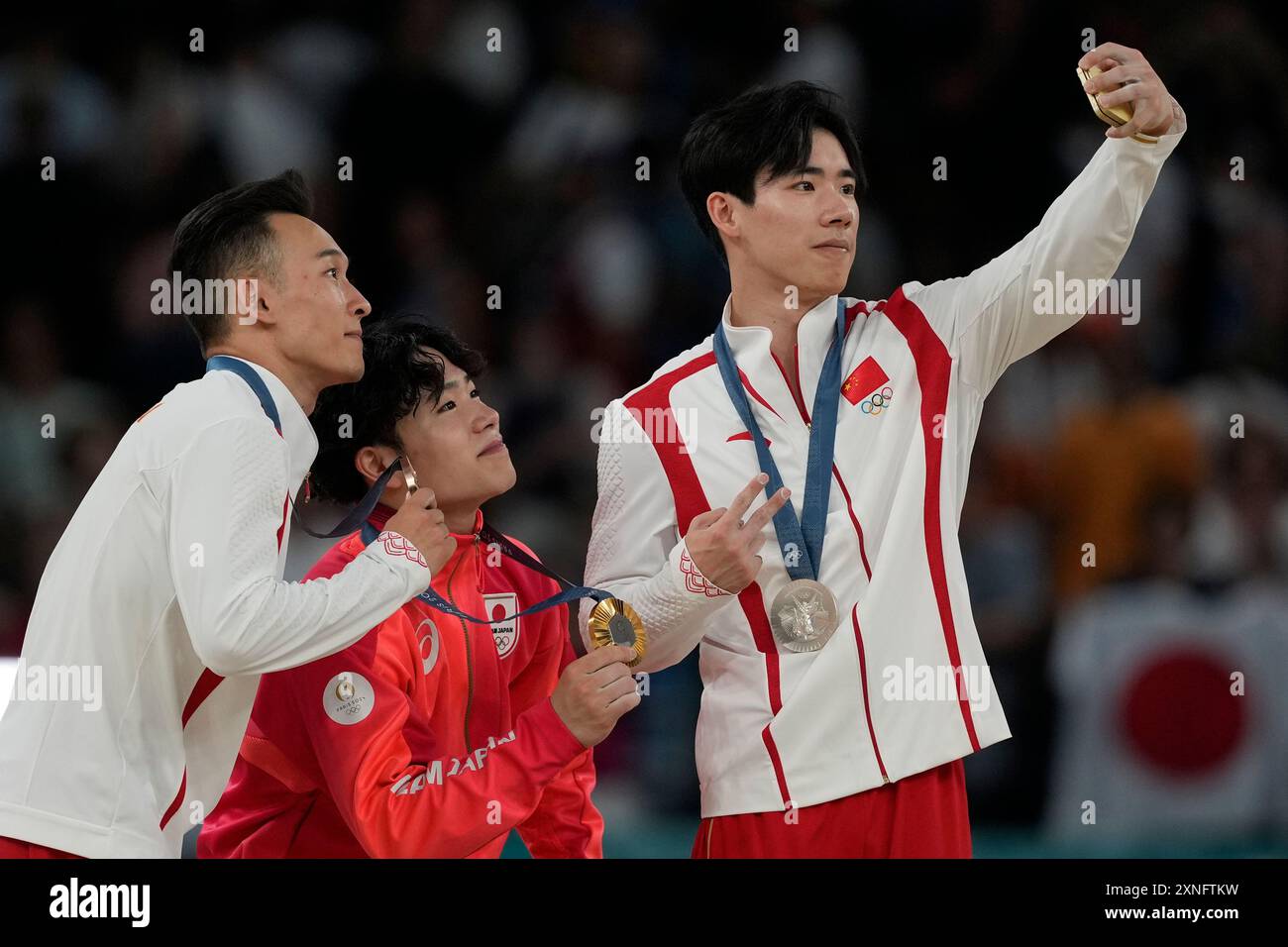 Shinnosuke Oka, center, of Japan, poses with his gold medal alongside ...