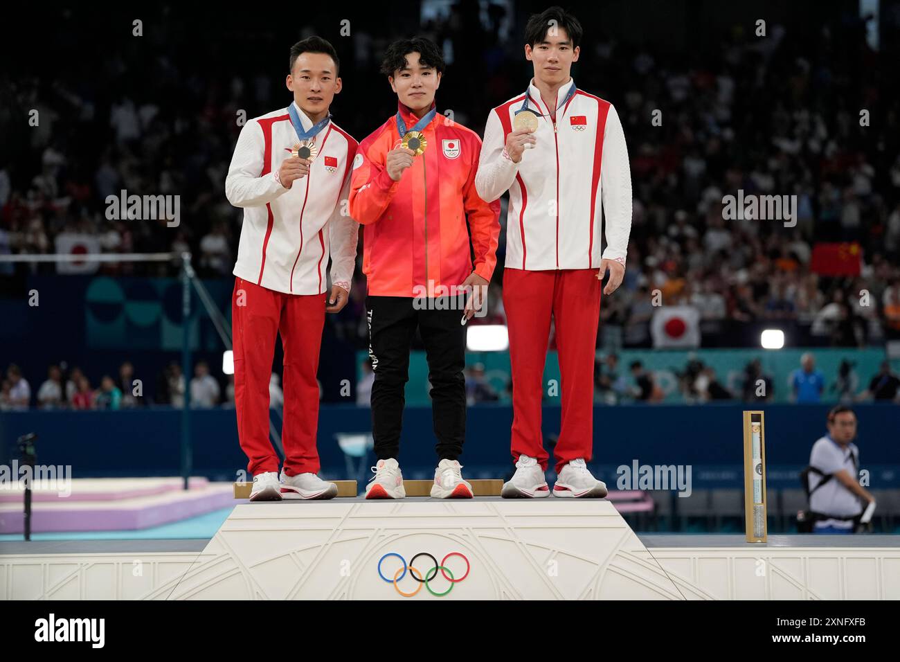 Shinnosuke Oka, center, of Japan, poses atop the podium with his gold ...